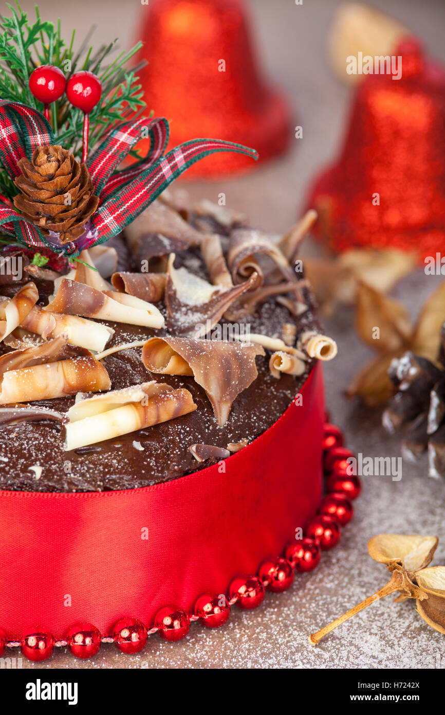 Chocolate christmas cake portrait with twirl topping in a red ribbon ...