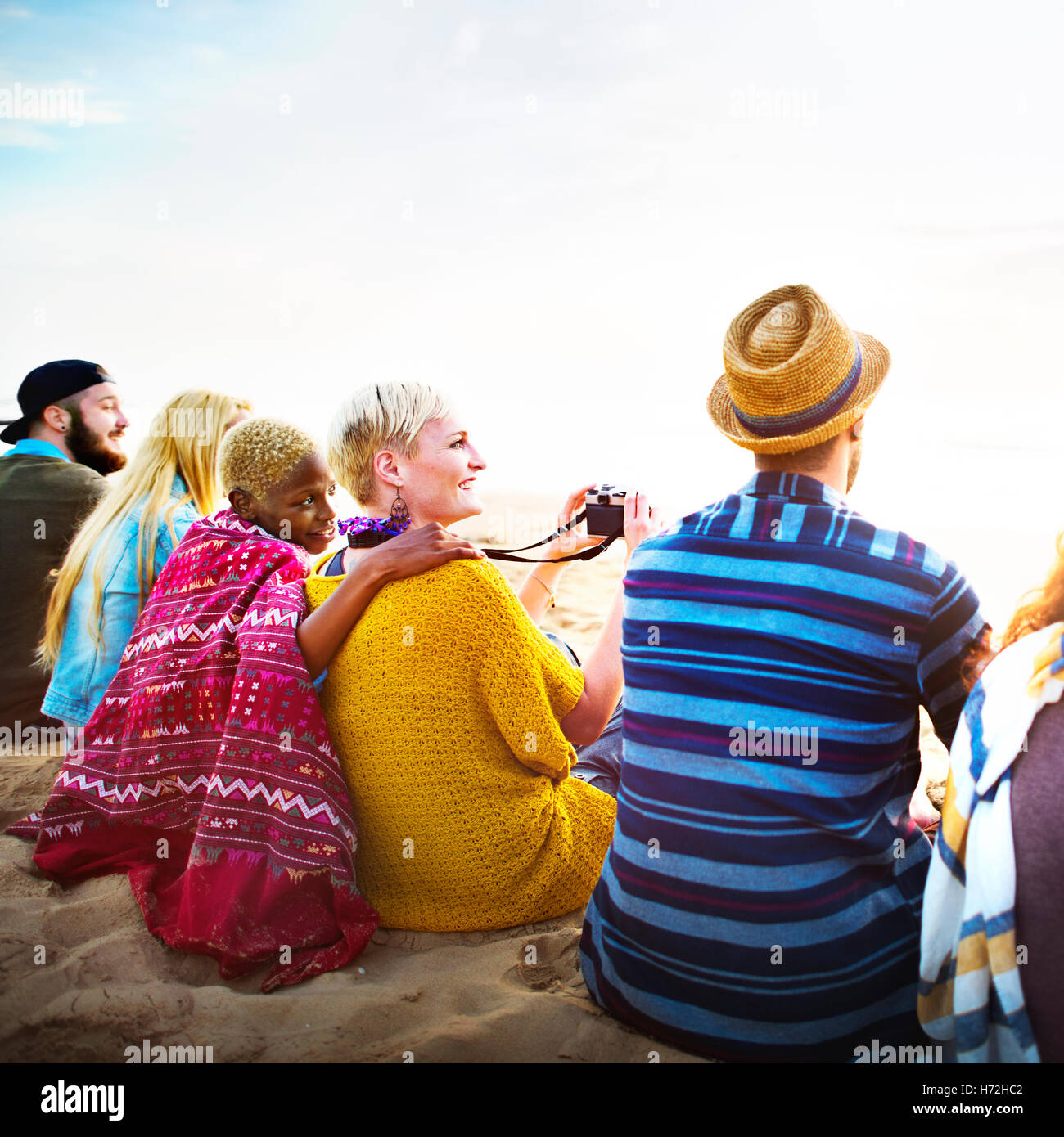 Group Of People Sitting On the Beach Concept Stock Photo - Alamy