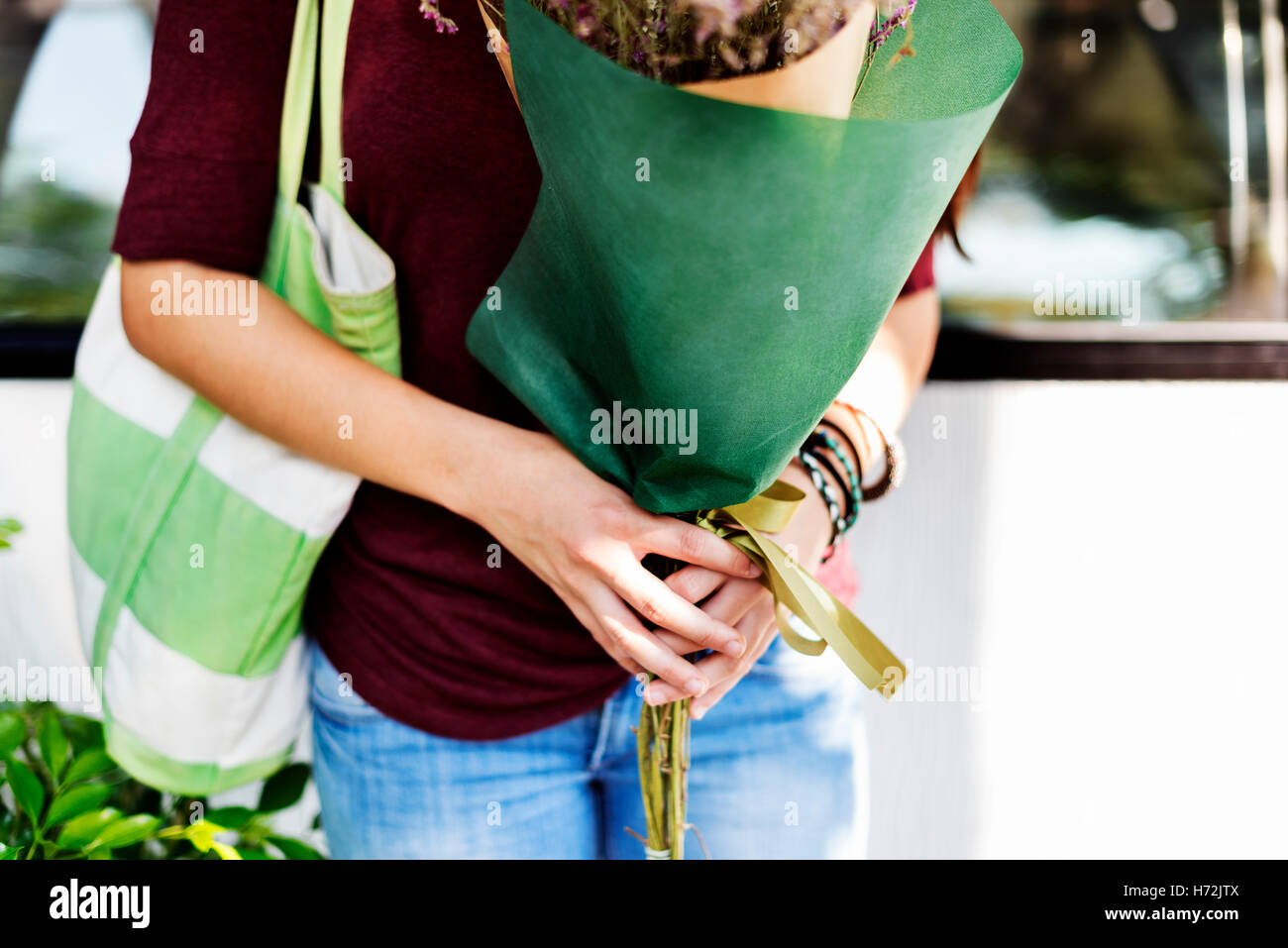 Attractive woman holding flowers hi-res stock photography and images ...