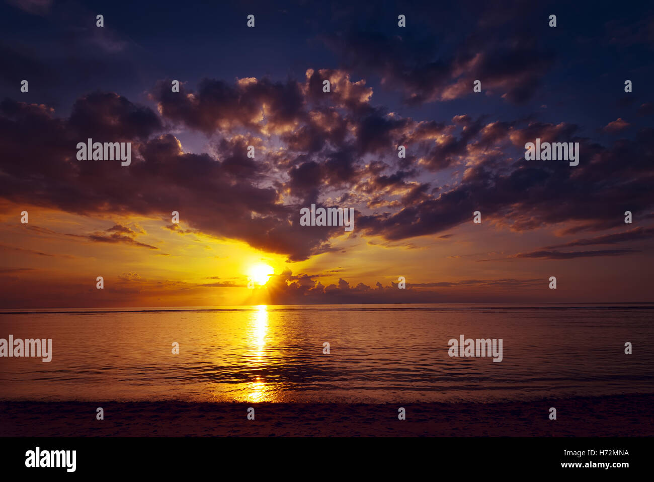 Tropical Sunset in The Middle of The Ocean with low clouds Stock Photo ...