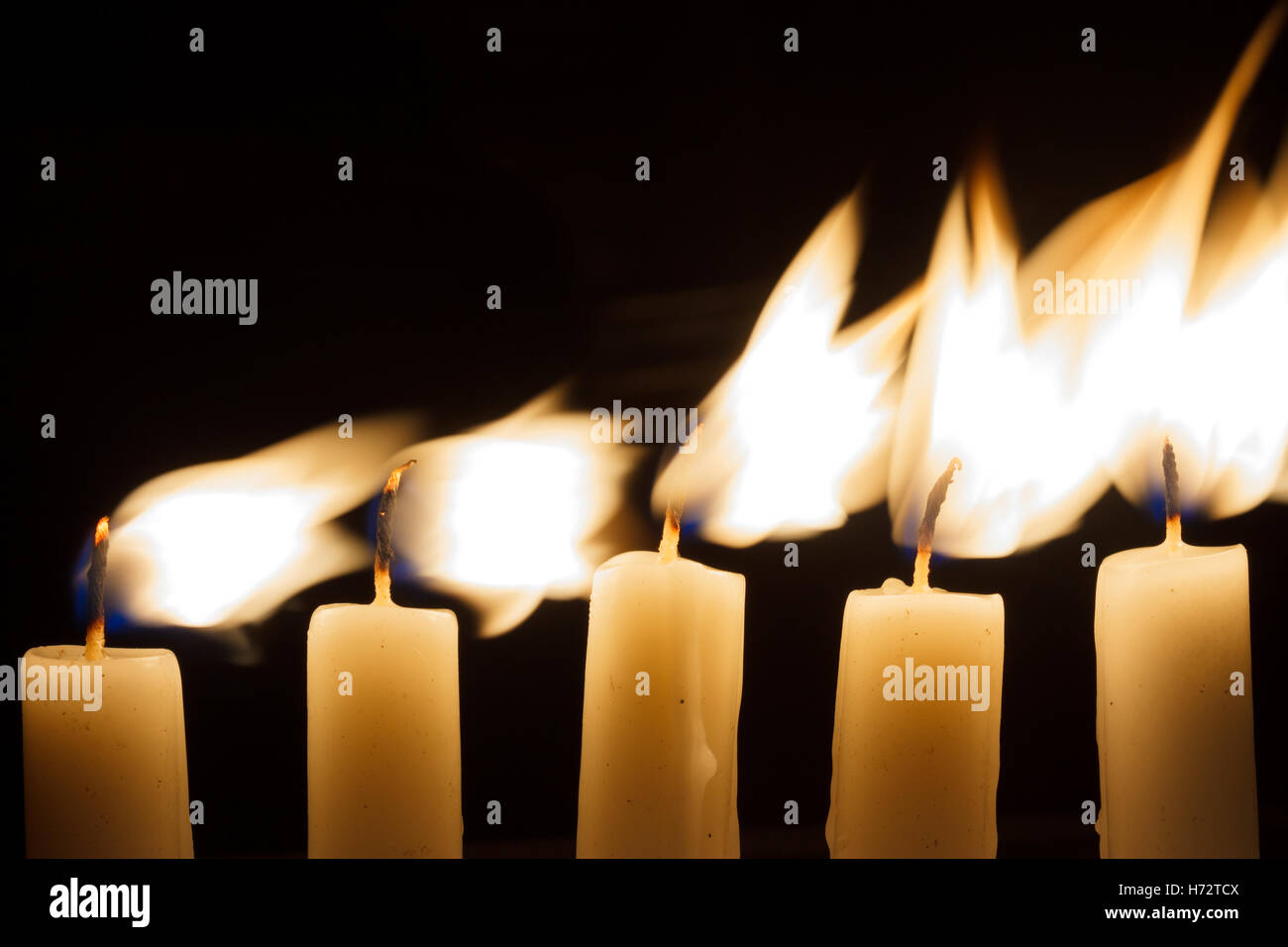 Candle's flame that blown by the wind with dark background Stock Photo ...