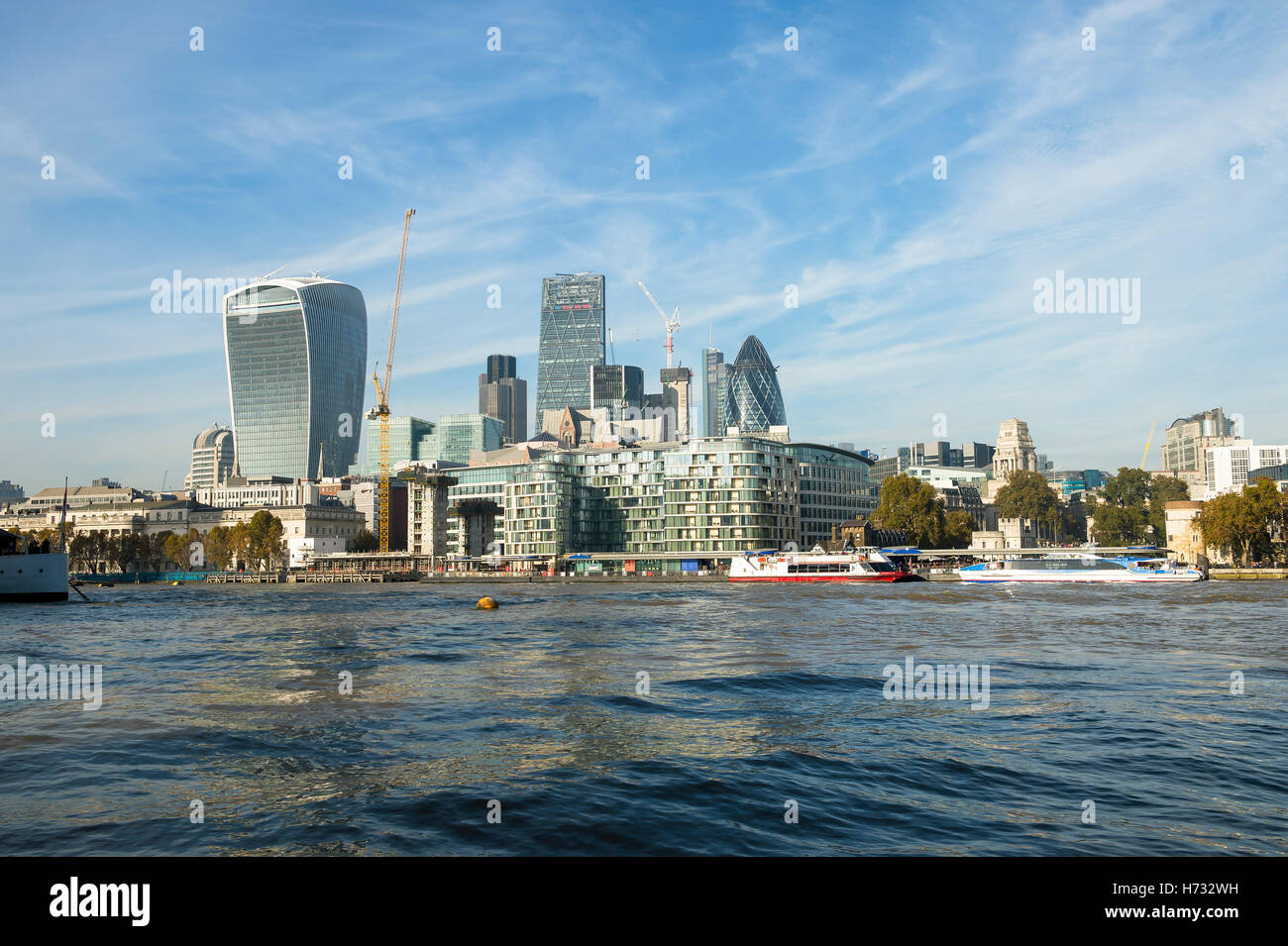 London skyline of the financial City center with the dark flowing ...