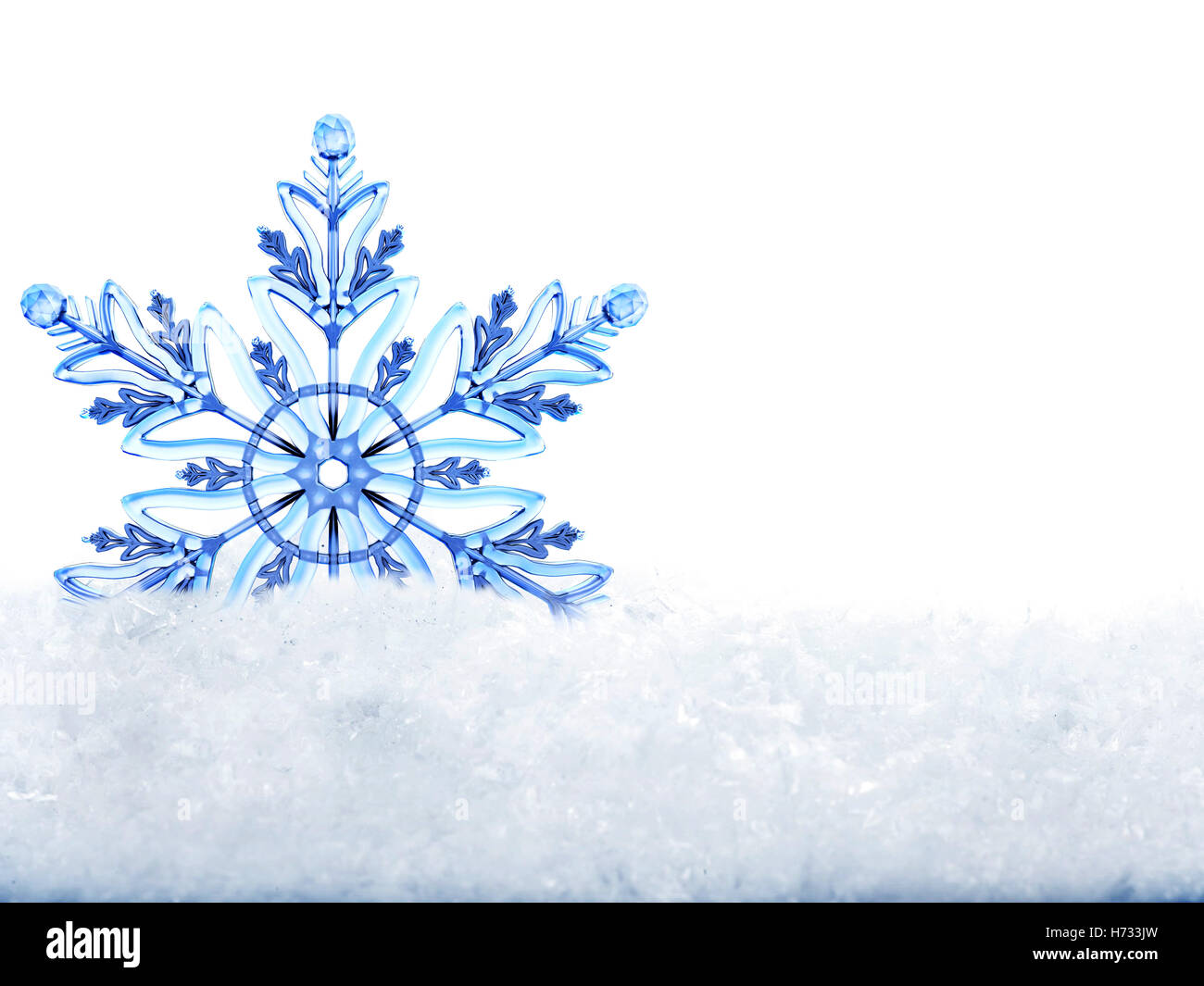 Snowflake in white snow. Isolated Stock Photo - Alamy