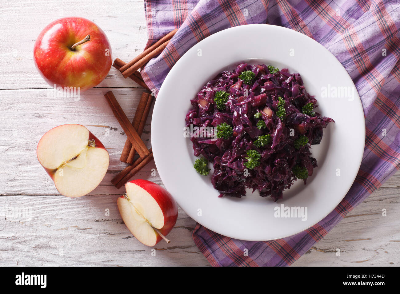 braised red cabbage with apples and cinnamon close-up on the table ...
