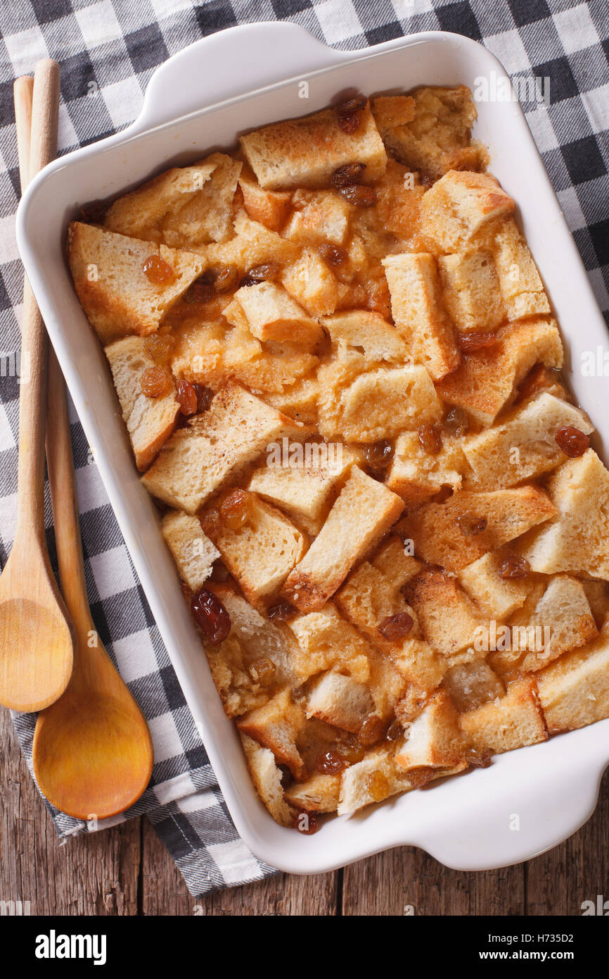 Fresh-baked English bread pudding with raisins close up in baking dish ...