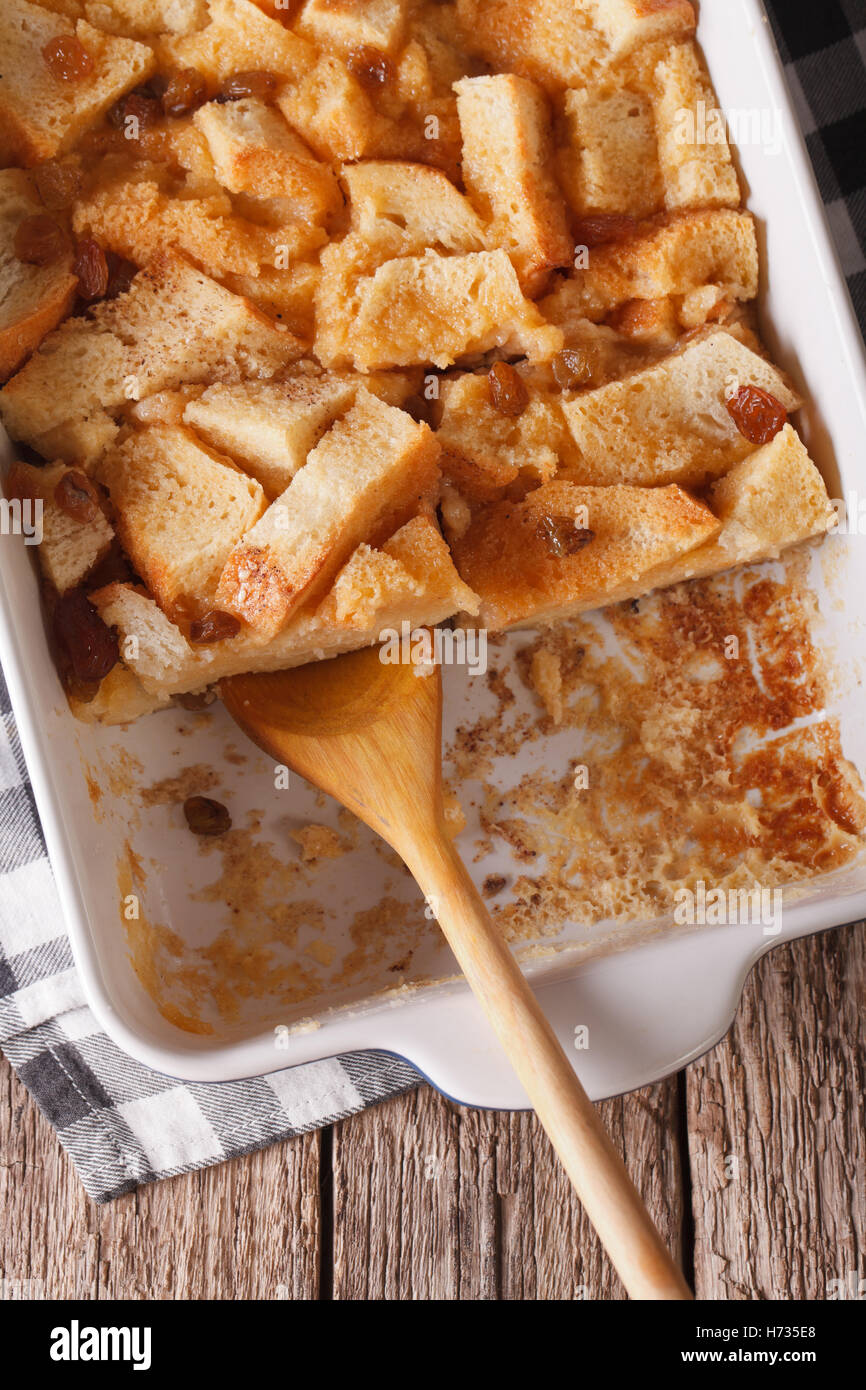 Bread pudding with raisins close up in baking dish. vertical view from ...