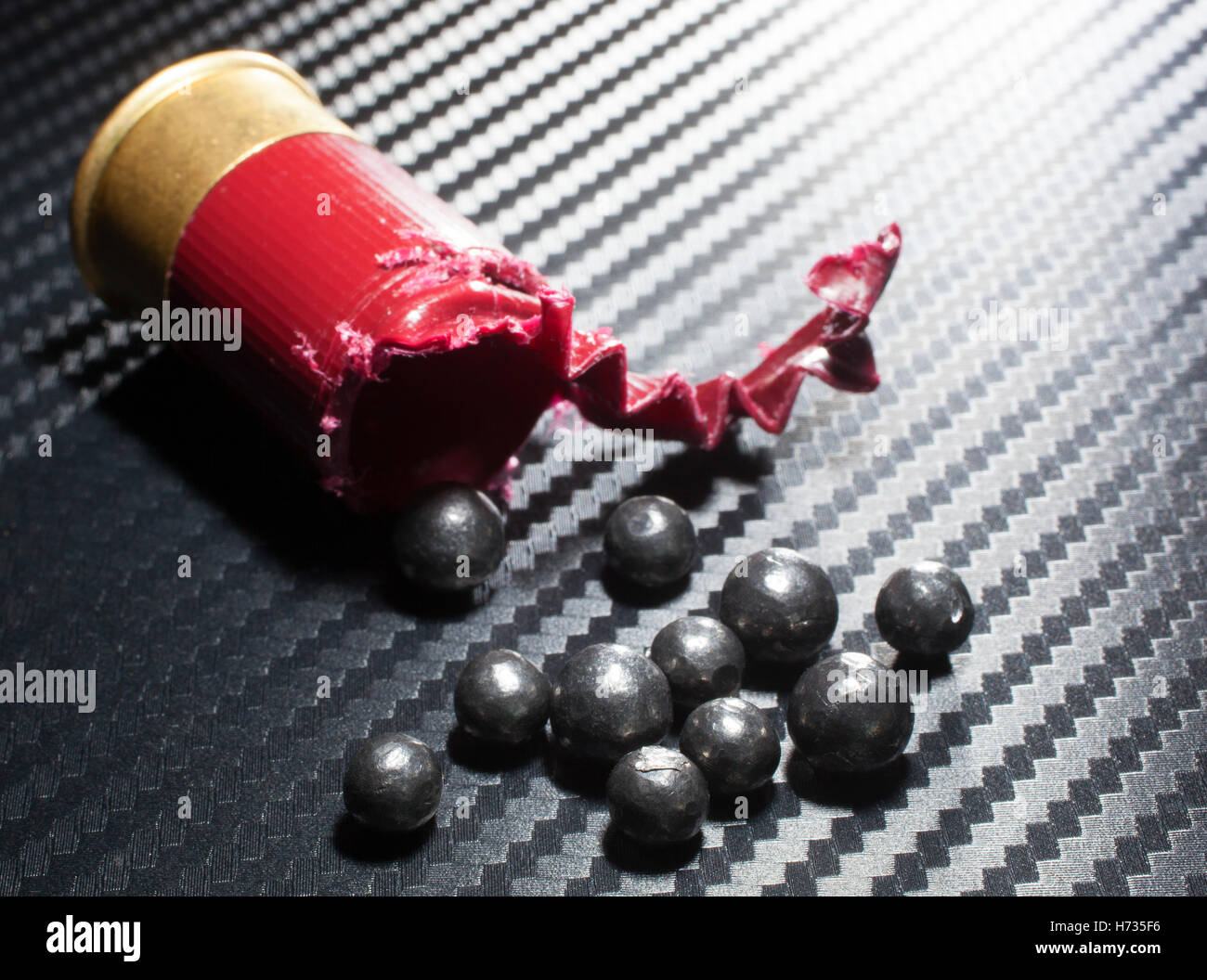 Short twelve gauge shotshell that is cut and buckshot rolling out Stock ...