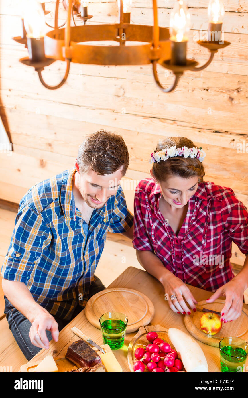 man and woman eating snacks at mountain hut Stock Photo - Alamy
