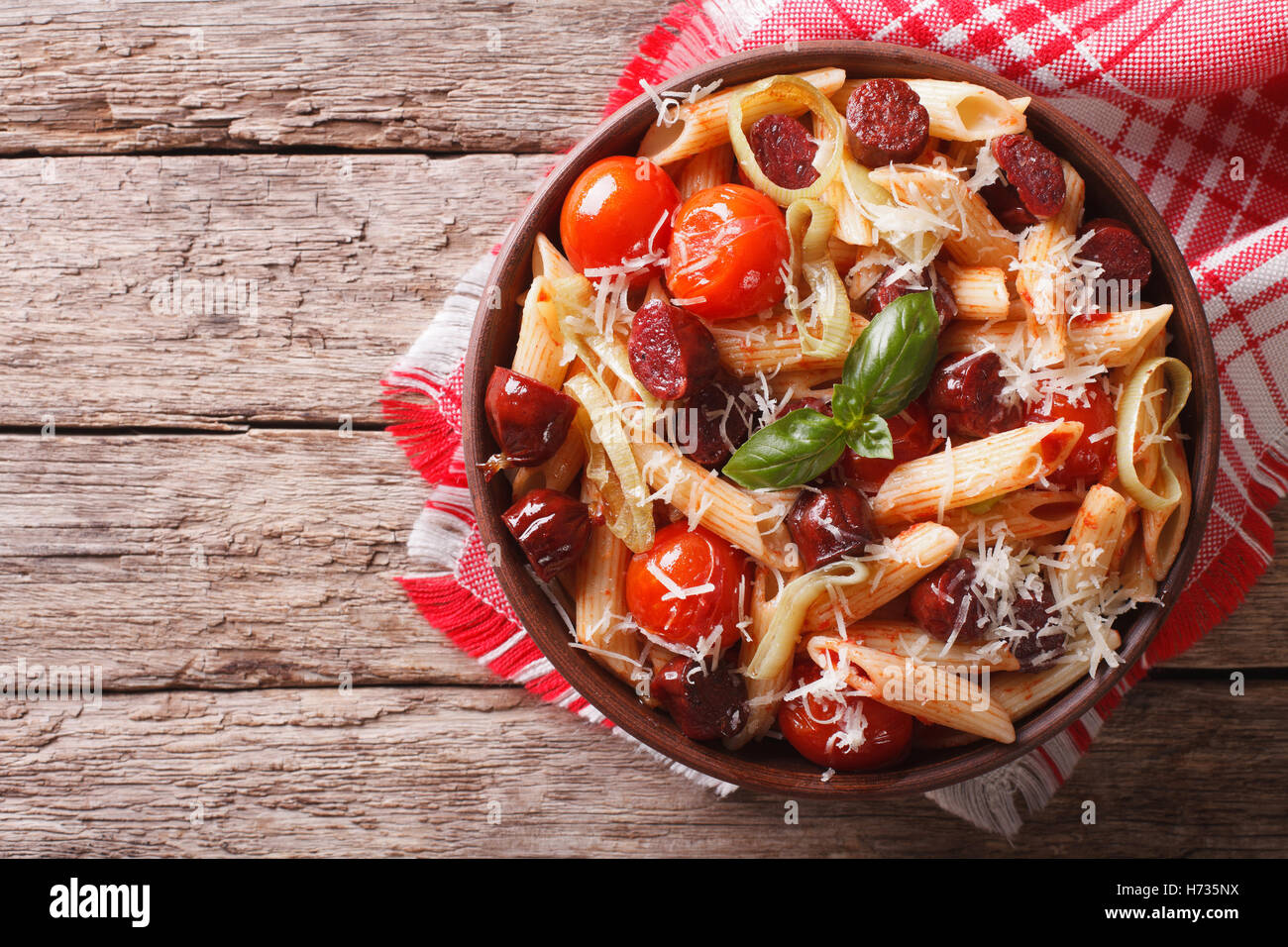 Penne Pasta With Sausage Leeks Cheese And Tomato In A Bowl On The Table Horizontal View From