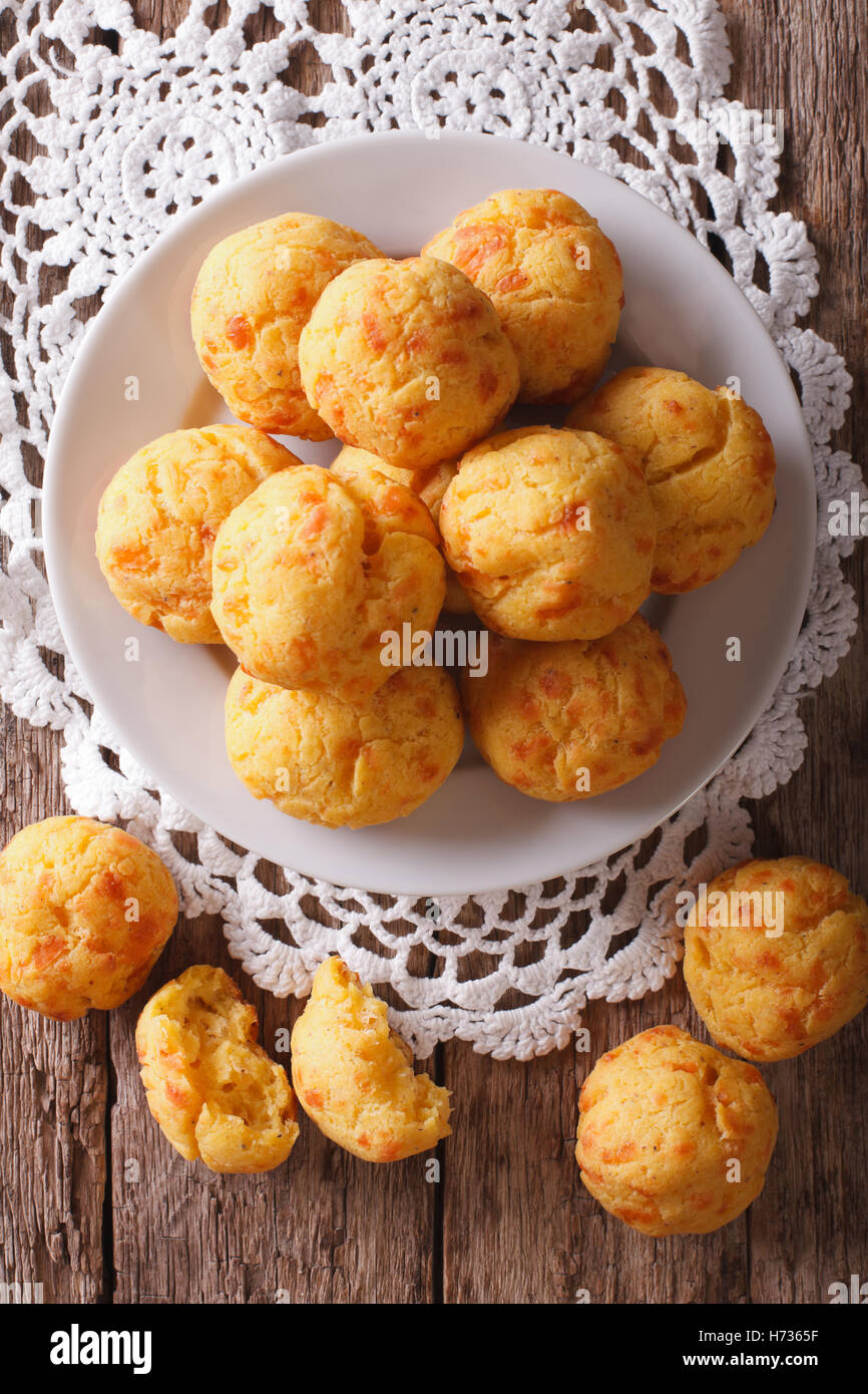French pastries gougere with cheese on a plate on the table. vertical ...