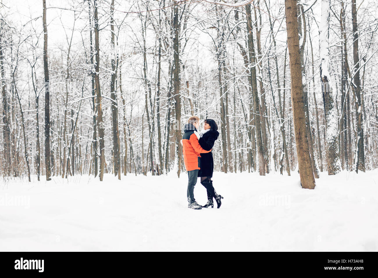 Happy Young Couple in Winter Park having fun. Family Outdoors Stock Photo - Alamy