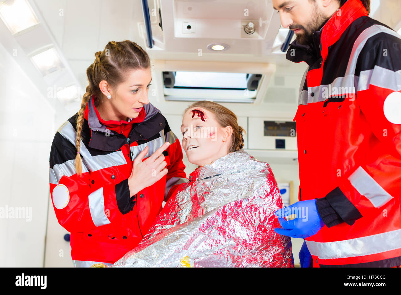 paramedics help injured woman Stock Photo - Alamy