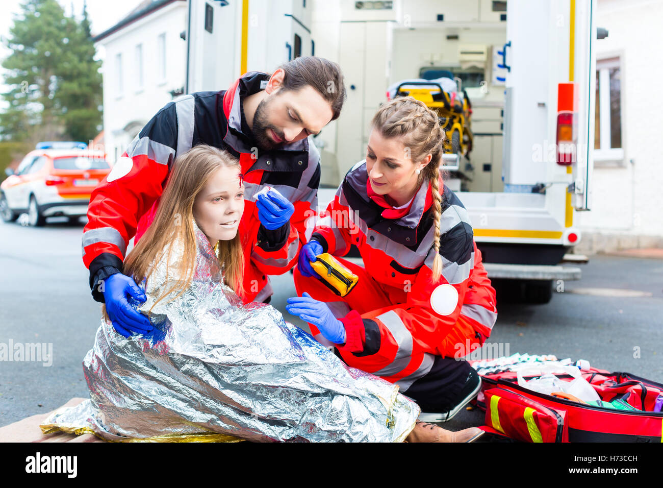 paramedics help injured woman Stock Photo - Alamy
