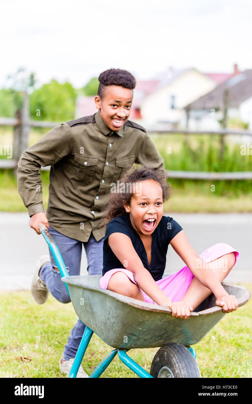 siblings play together in the garden Stock Photo - Alamy