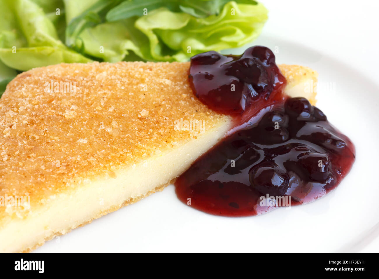 Fried cheese, cut, melting, cranberry sauce, salad Stock Photo - Alamy