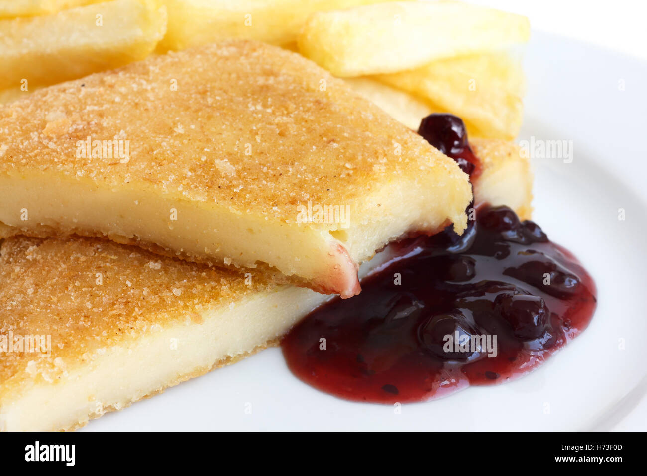 Fried cheese, cut, melting, cranberry sauce, fries. Bite Stock Photo ...