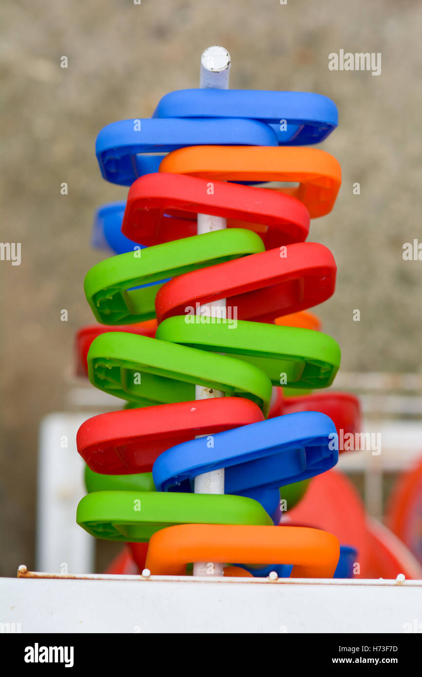 Childrens spades in lots of colours for sale at stall at the seaside in ...