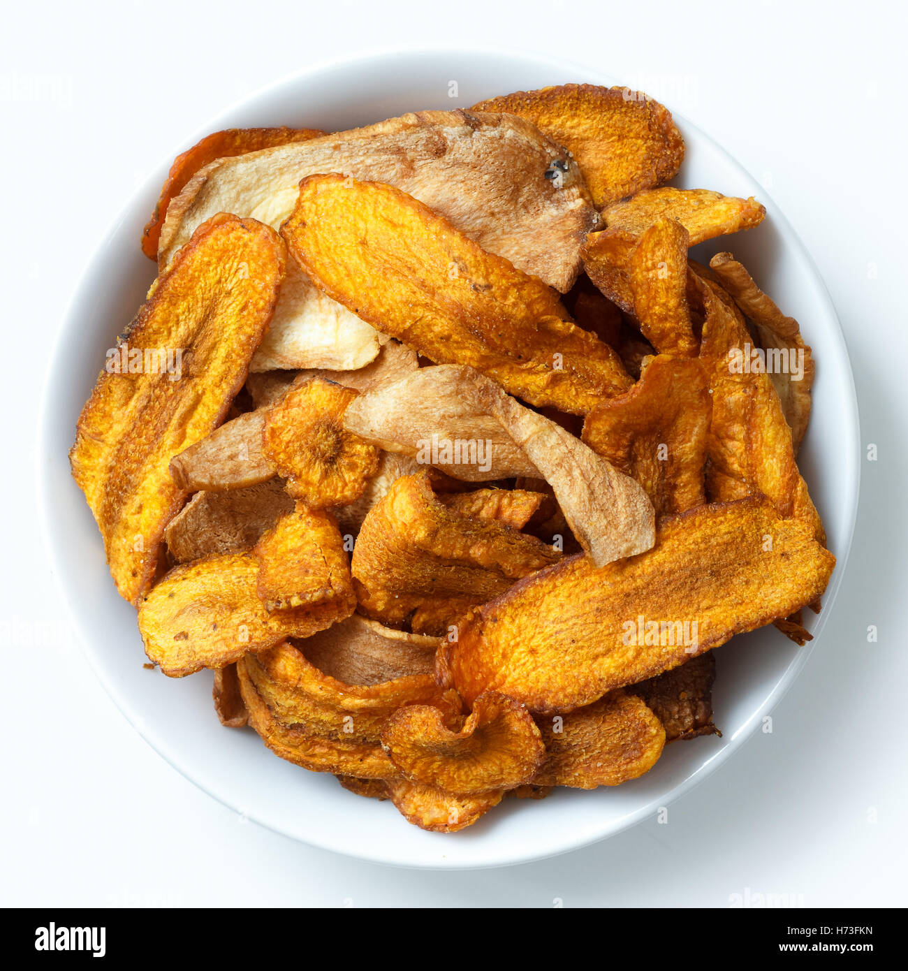 Bowl of fried carrot and parsnip chips. Isolated from above Stock Photo ...