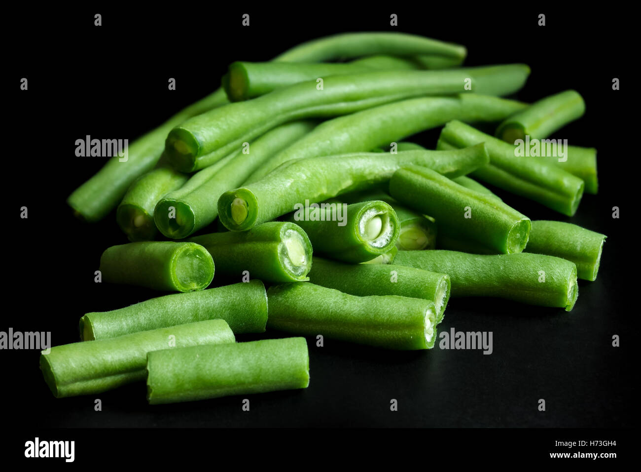 Whole French green string beans cut and isolated on black Stock Photo ...