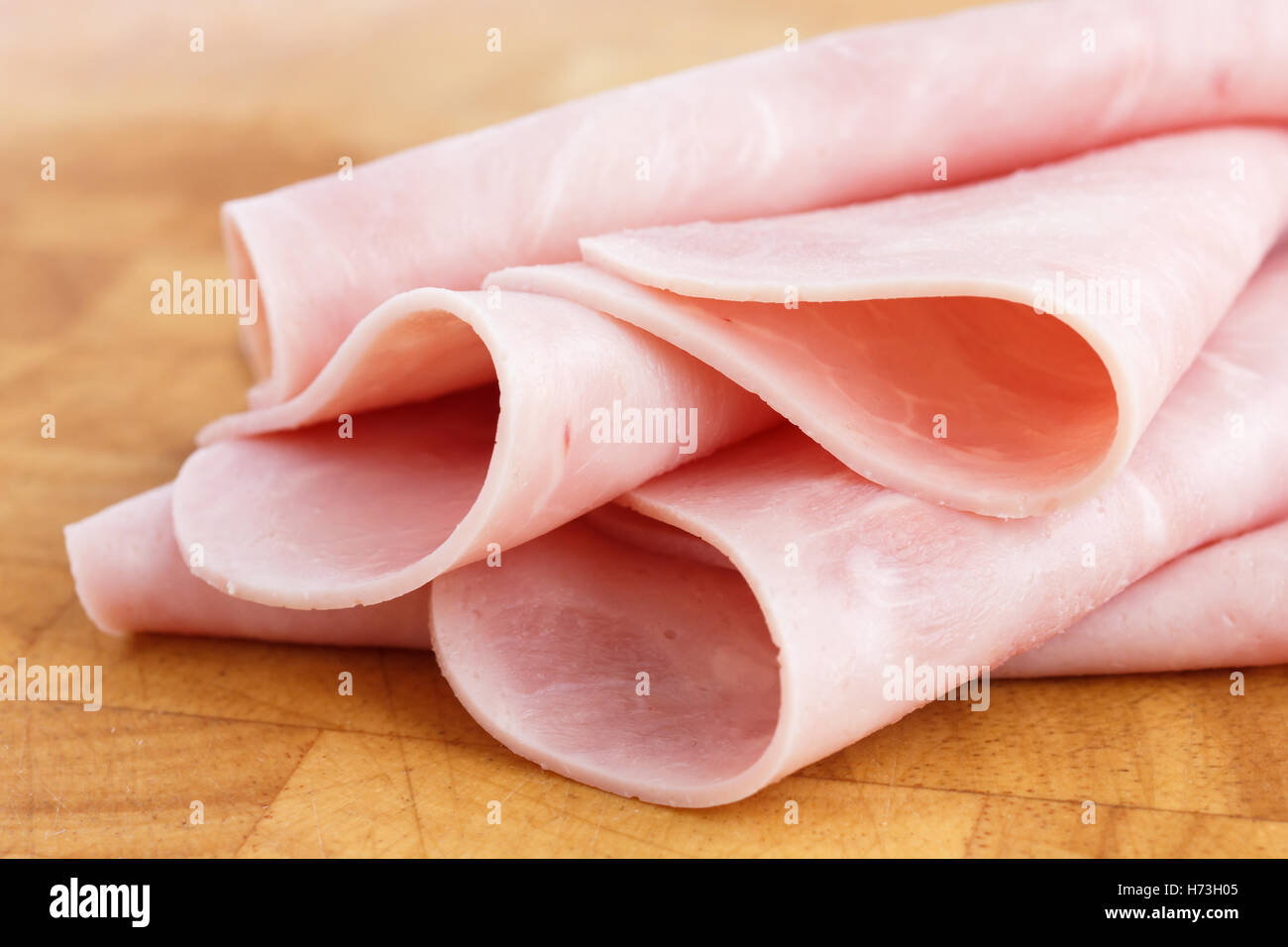 Processed ham randomly arranged on chopping board Stock Photo - Alamy