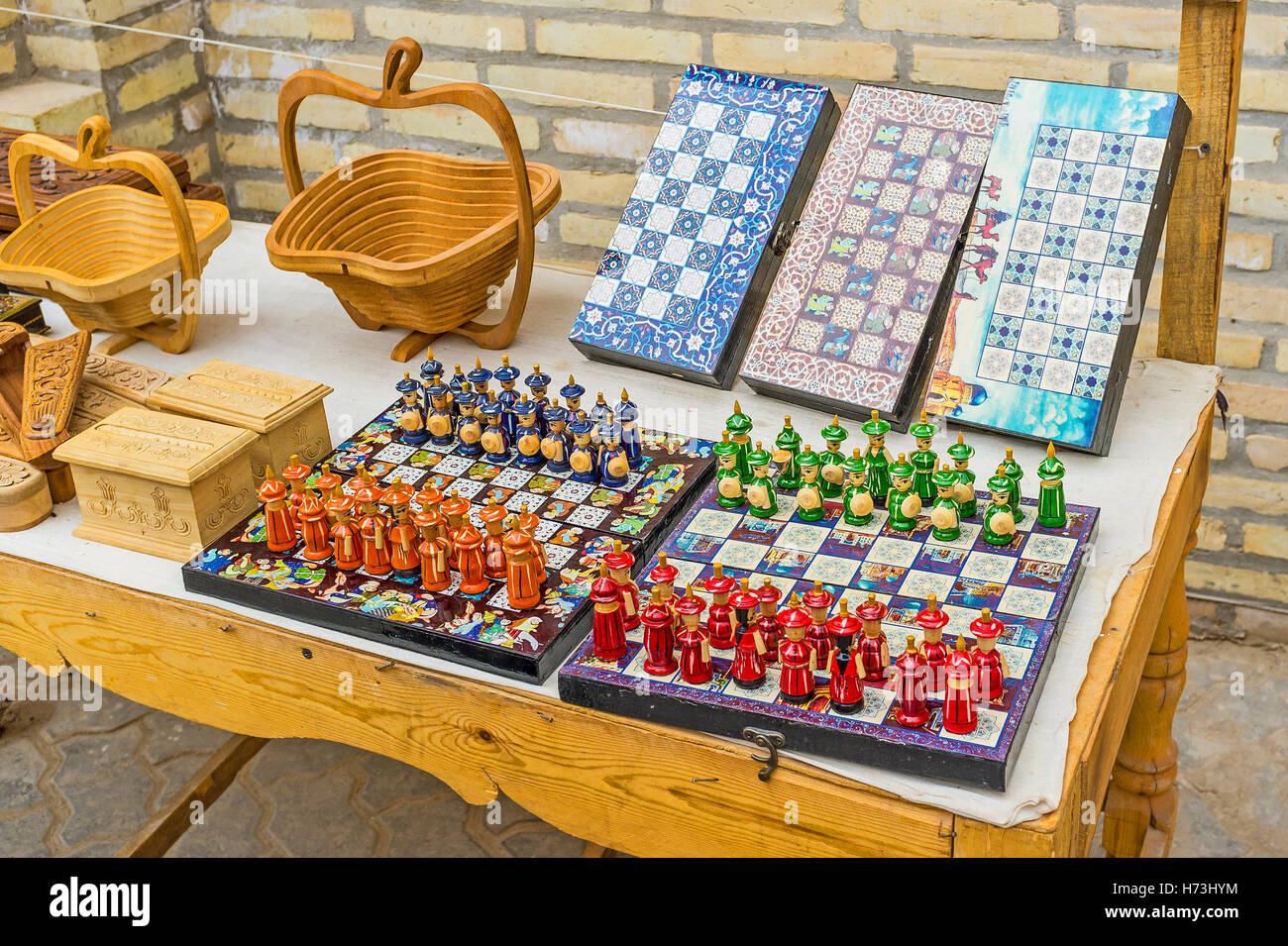 The hand made wooden chess with the colorful painted chessmen ...