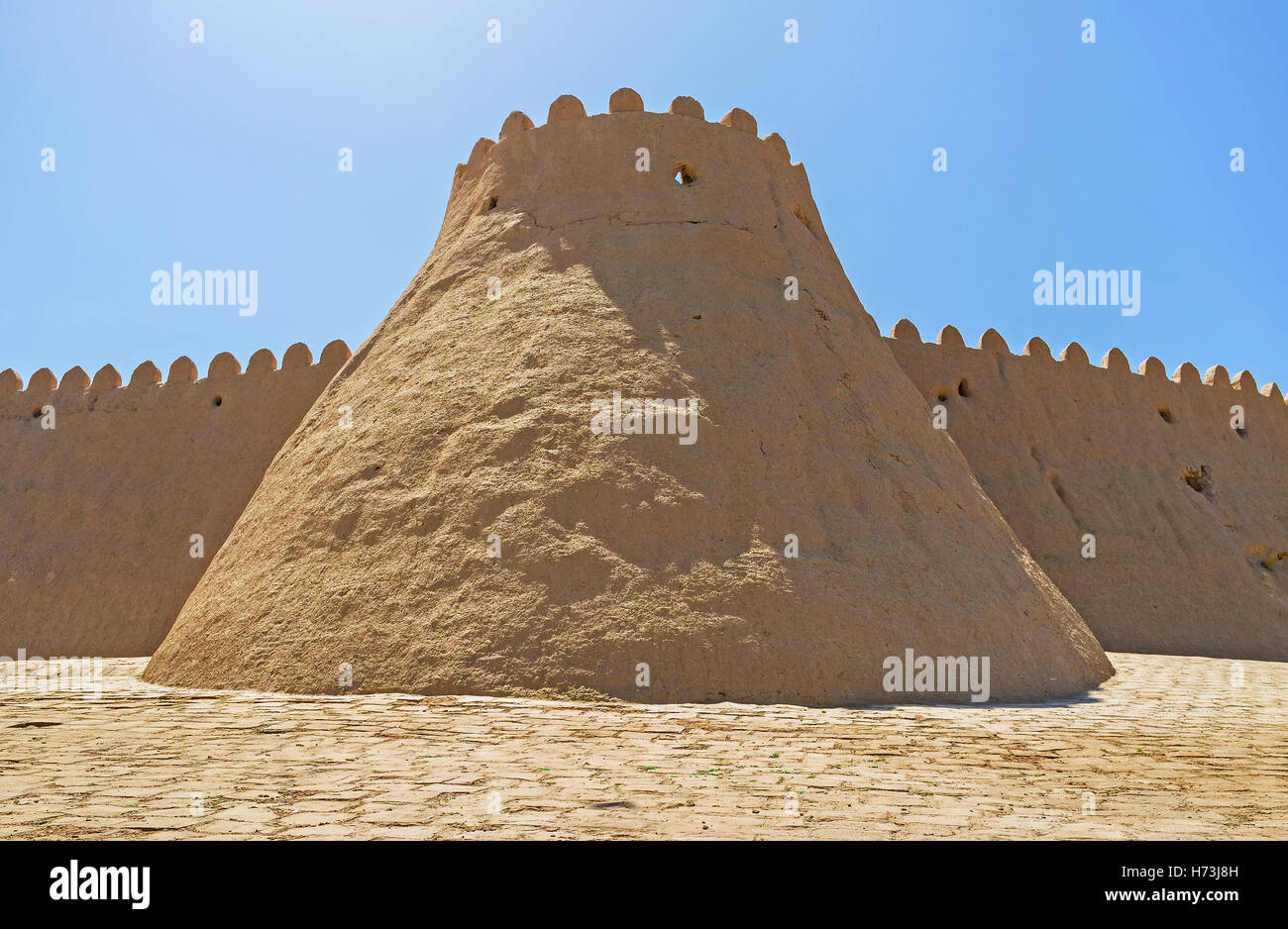 The clay tower of the medieval fortification in Khiva, Uzbekistan Stock ...