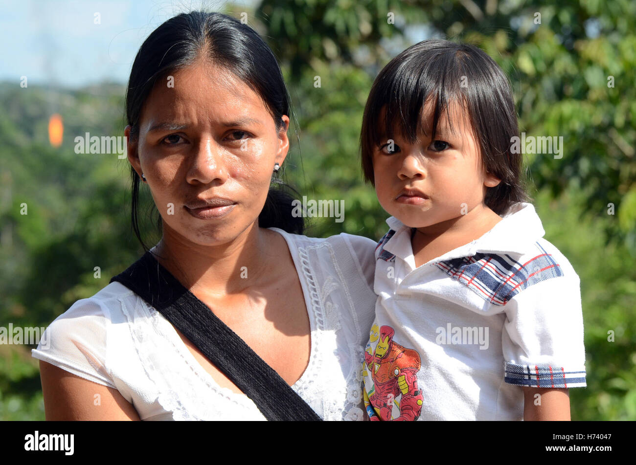 Silvia Shiguango of the indigenous Huaorani tribe stands with her young ...
