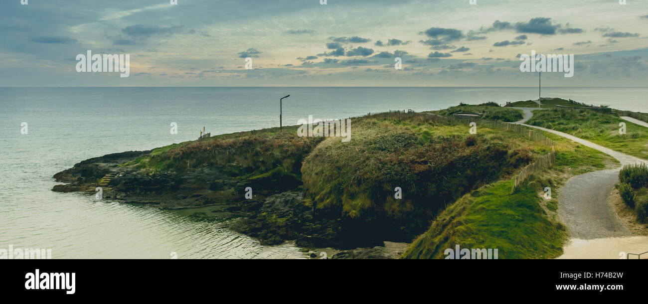 The side view of the clonakilty headland with a small harbour on the ...