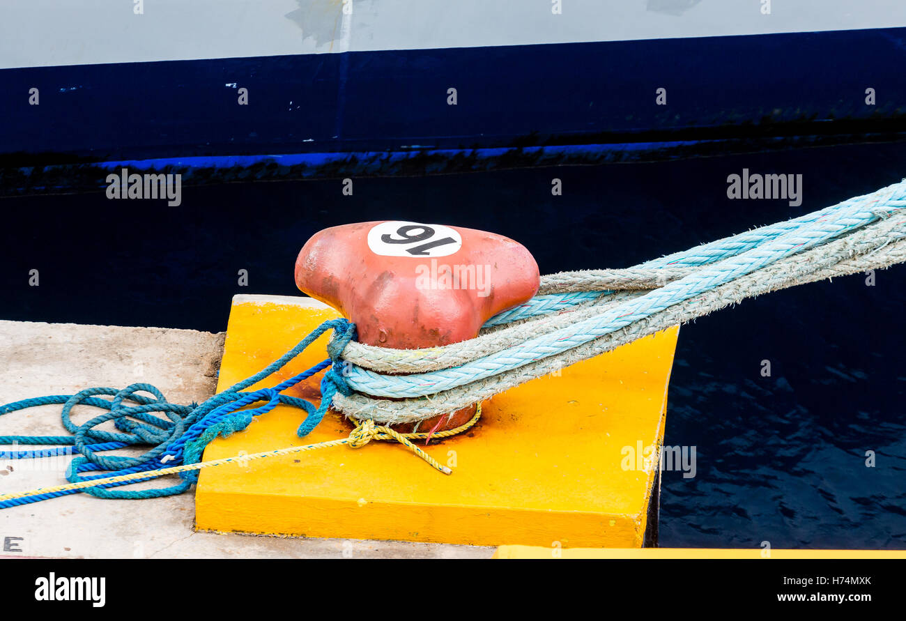 Blue Ropes on a Red Bollard in a Harbor Stock Photo - Alamy