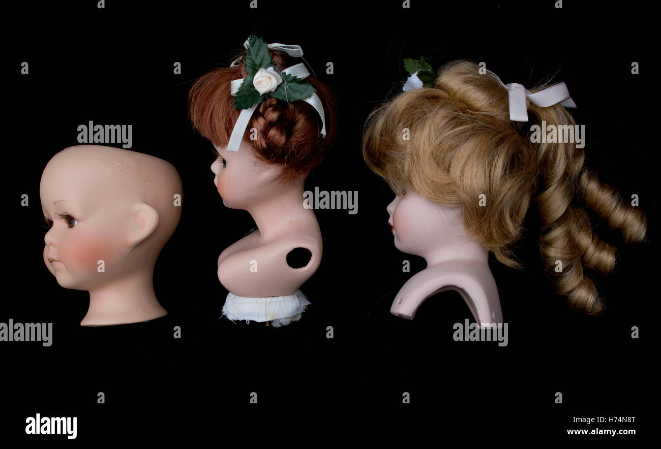 Three Doll Heads on Black Background Stock Photo - Alamy