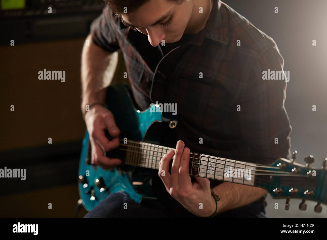Man Playing Electric Guitar In Studio Stock Photo - Alamy