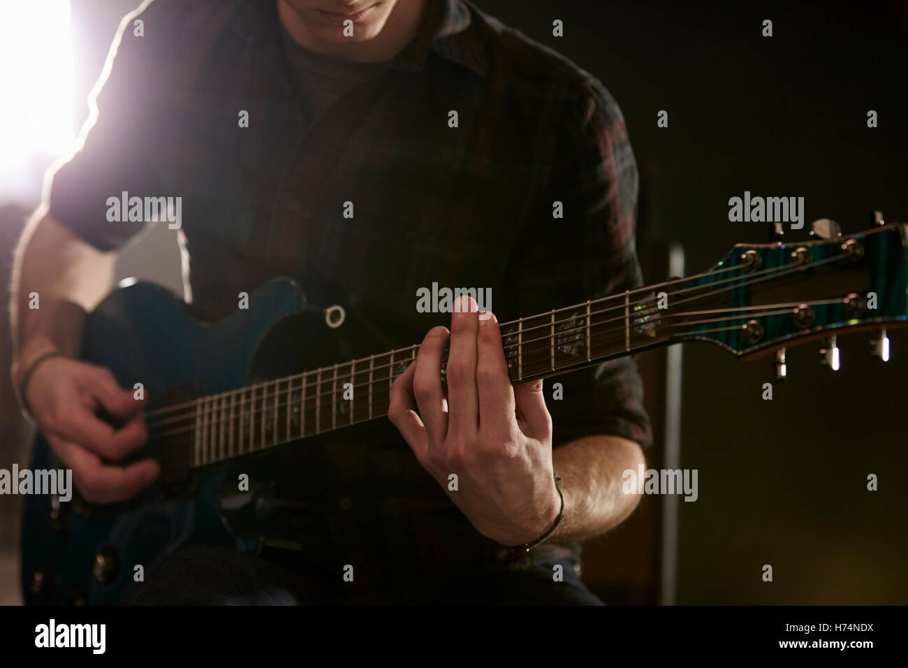 Close Up Of Man Playing Electric Guitar In Studio Stock Photo - Alamy