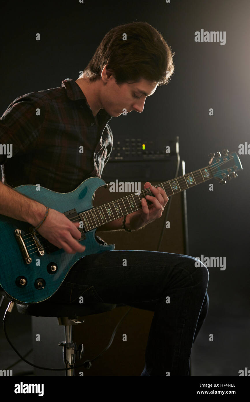 Man Playing Electric Guitar In Studio Stock Photo - Alamy