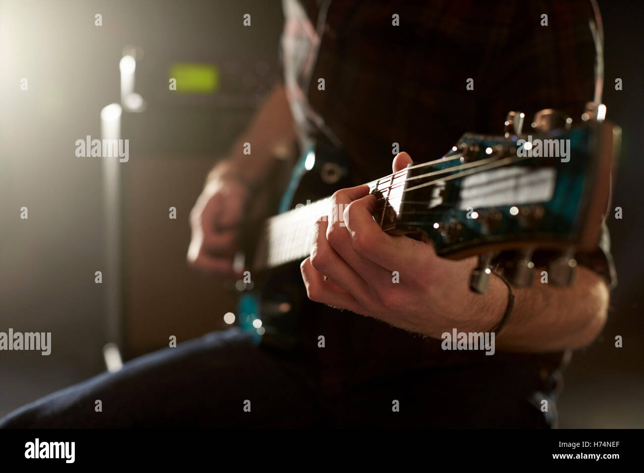 Close Up Of Man Playing Electric Guitar In Studio Stock Photo - Alamy