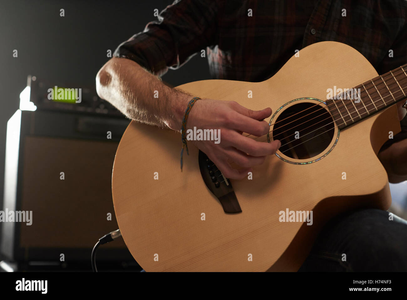 Close Up Of Man Playing Amplified Acoustic Guitar Stock Photo - Alamy
