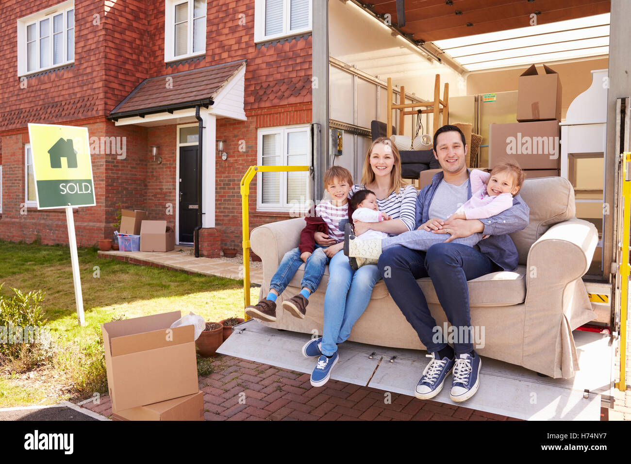 Family With Sofa On Tail Lift Of Removal Truck Moving Home Stock Photo ...