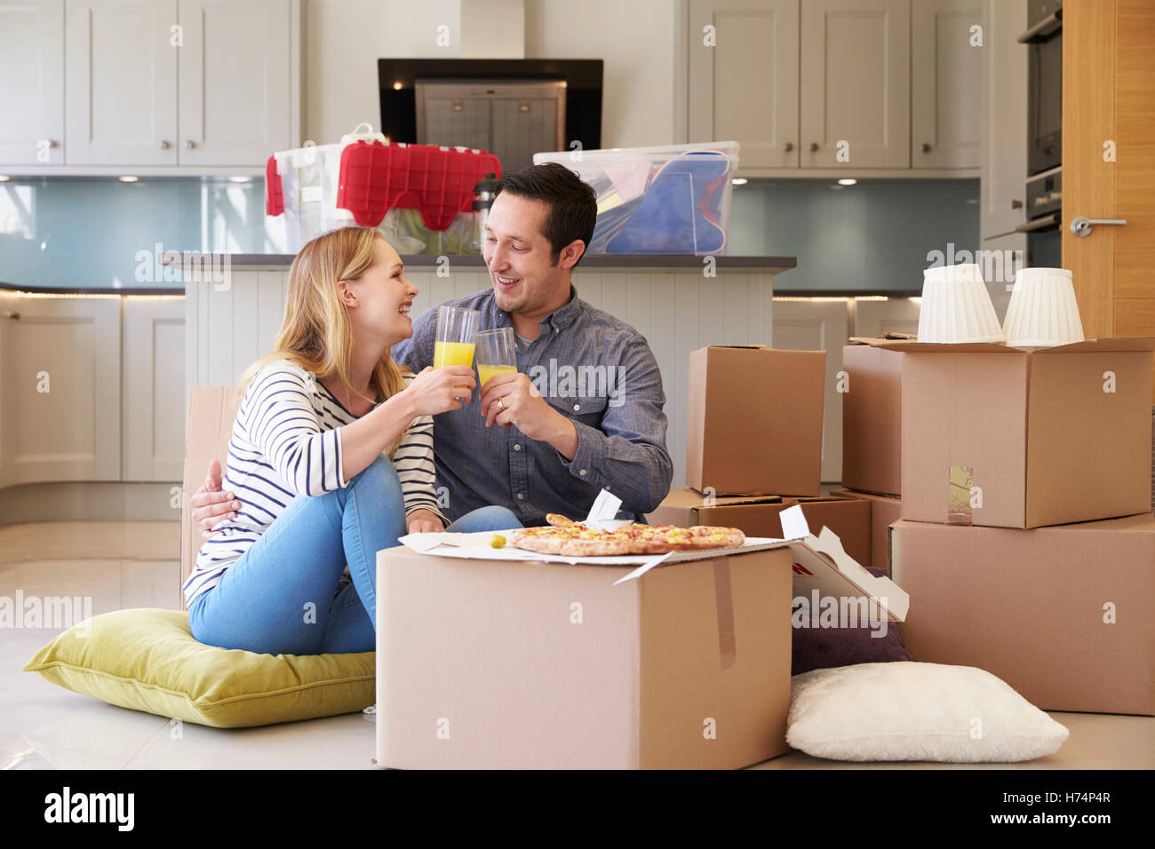 Couple Celebrating Moving Into New Home With Pizza Stock Photo - Alamy