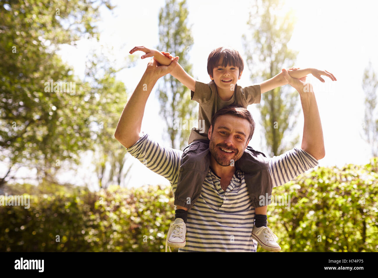 Father Giving Son Ride On Shoulders During Walk Stock Photo - Alamy