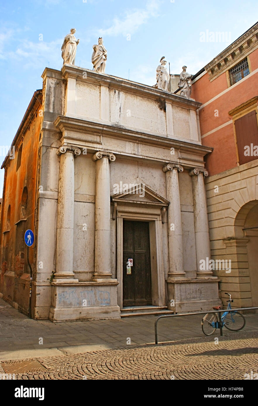 The tiny chapel with scenic marble facade is tilted on the house wall ...