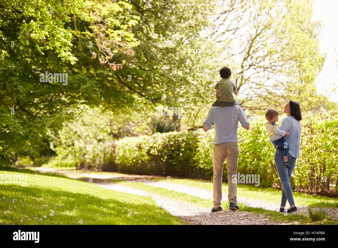 Rear View Of Family Going For Walk In Summer Countryside Stock Photo ...