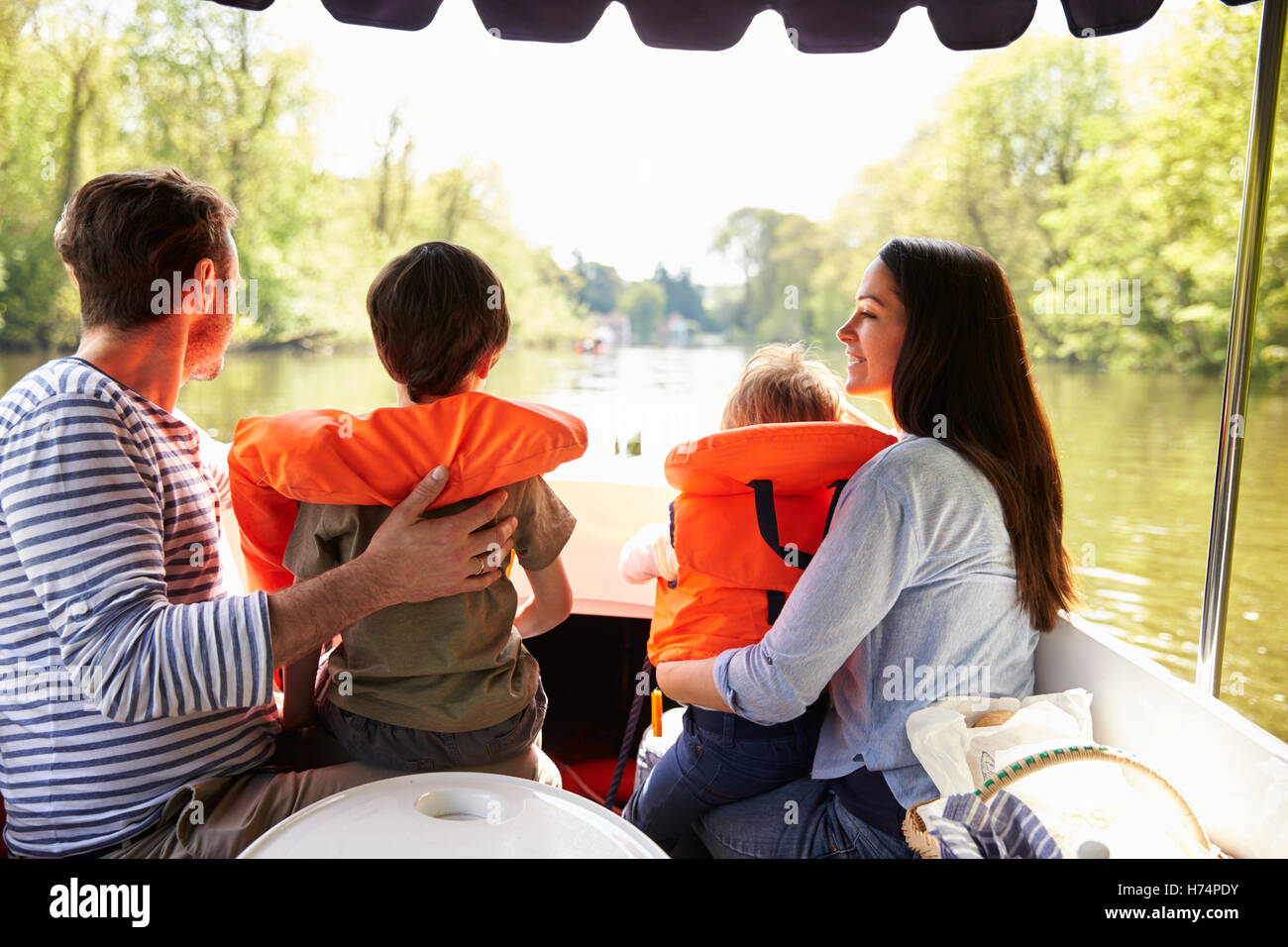 Family Enjoying Day Out In Boat On River Together Stock Photo - Alamy