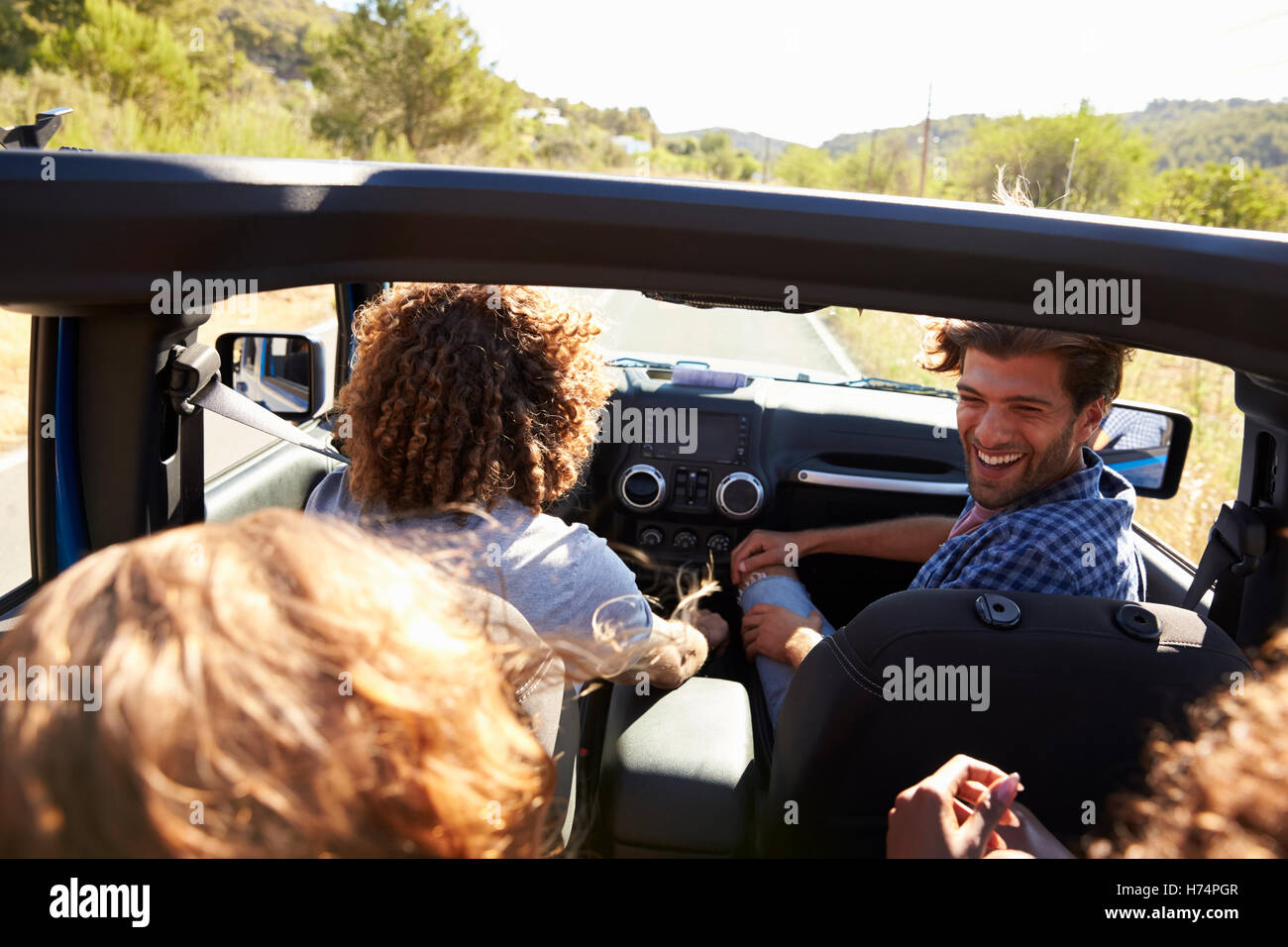 Four Friends Driving In Open Top Car High Resolution Stock Photography ...