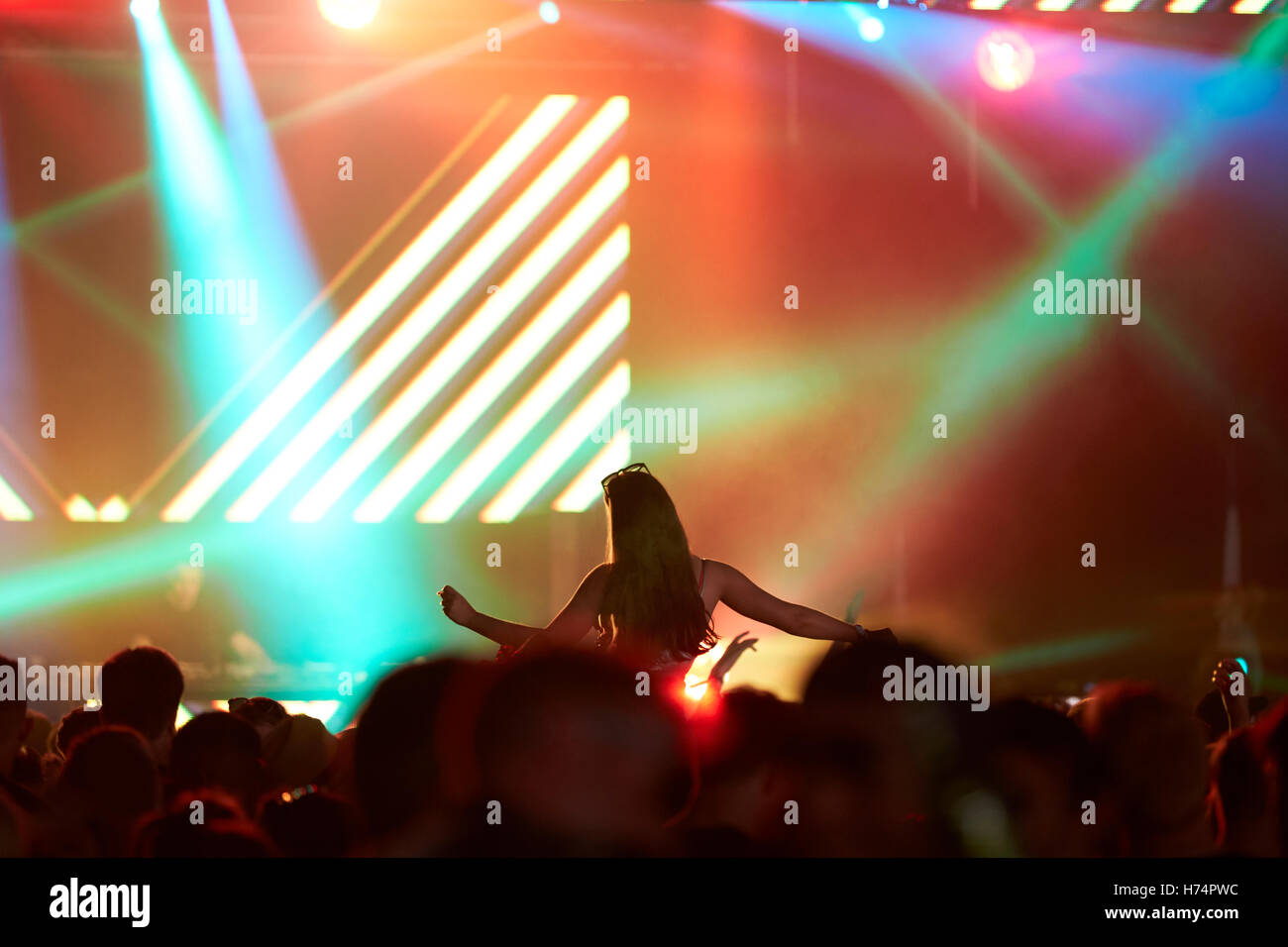 Woman Sitting On Friend's Shoulders At Music Festival Stock Photo - Alamy