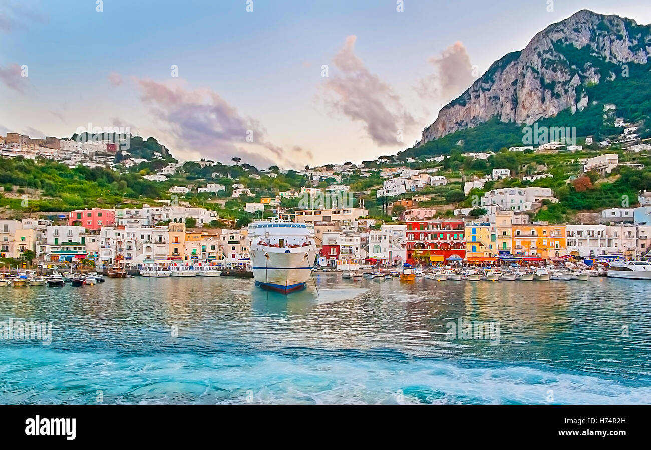 The ship changes direction in the Marina Grande harbour, Capri island ...