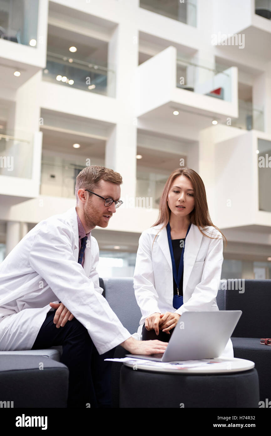 Two Doctors Having Meeting In Hospital Reception Area Stock Photo - Alamy