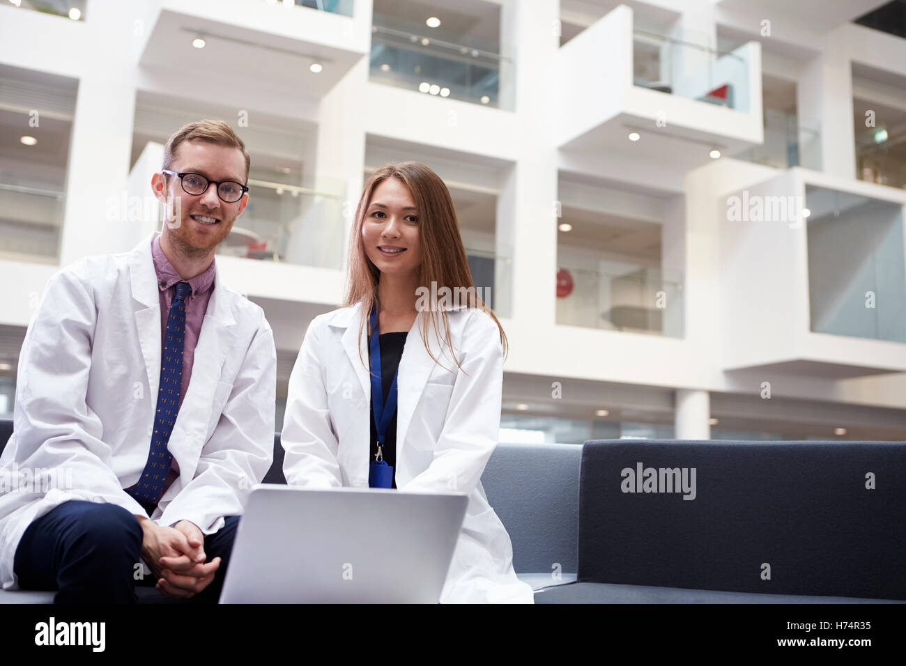 Portrait Of Two Doctors Meeting In Hospital Reception Area Stock Photo ...