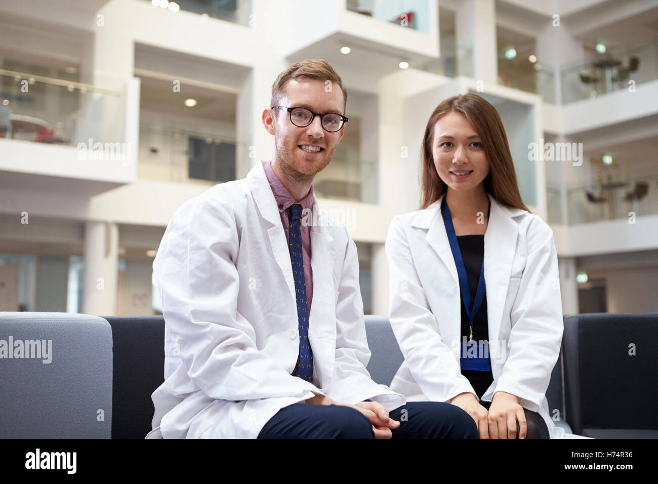 Portrait Of Two Doctors Meeting In Hospital Reception Area Stock Photo ...