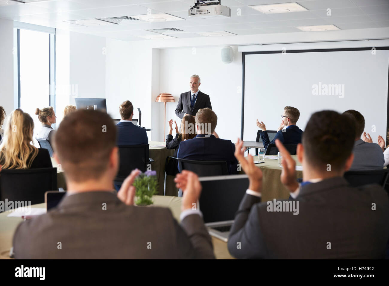 Mature Businessman Making Presentation At Conference Stock Photo - Alamy