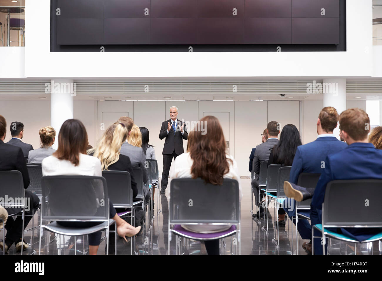 Mature Businessman Making Presentation At Conference Stock Photo - Alamy