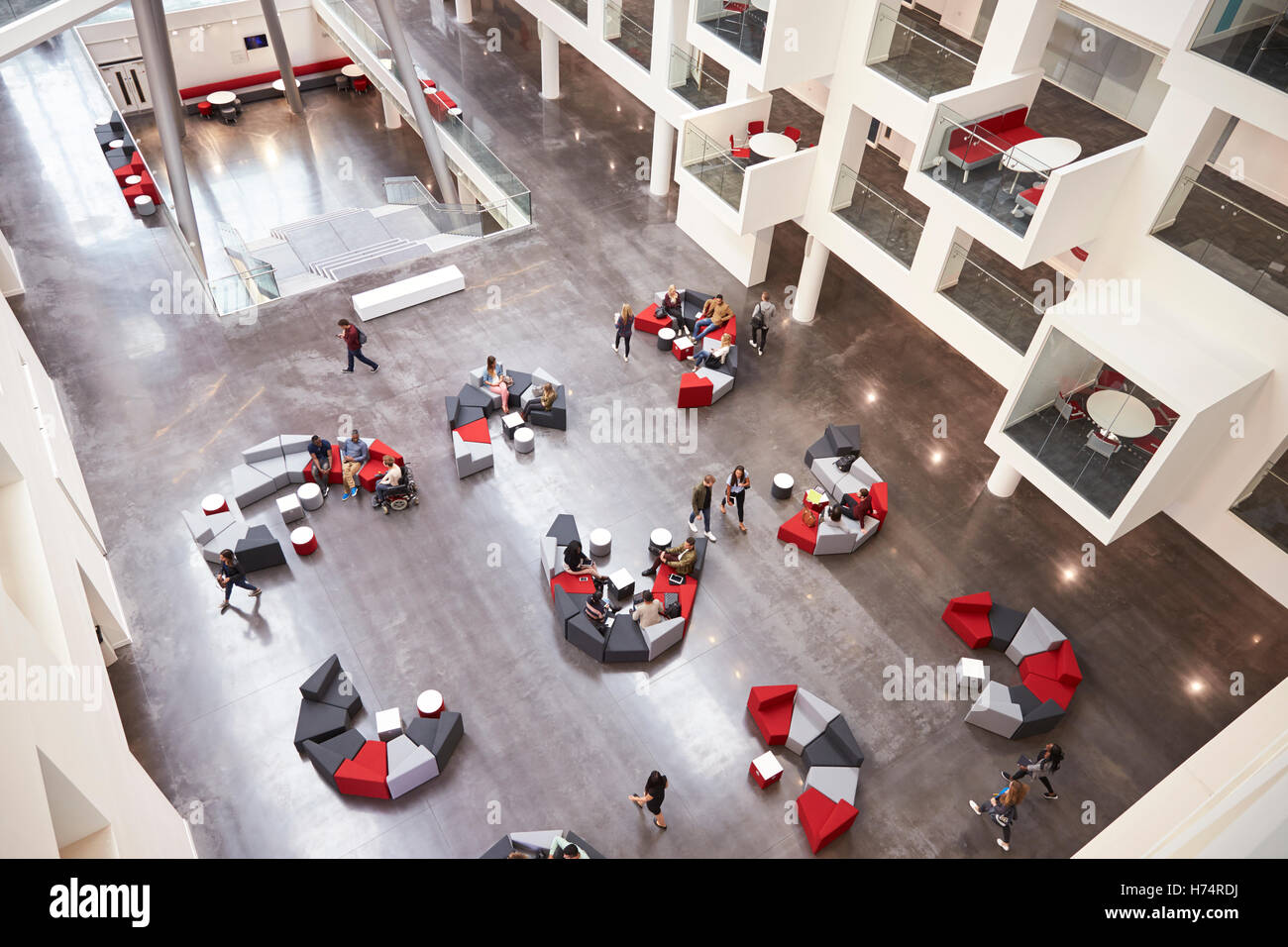 Students in the atrium of modern university building, aerial Stock ...